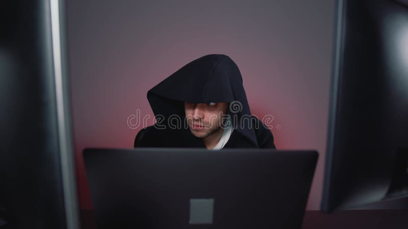 Man Hacker in Black Hood, Working with Several Computers Evil Smile ...