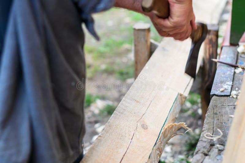 A Man Hacking a Wooden Board with an Ax Stock Photo - Image of crafts ...
