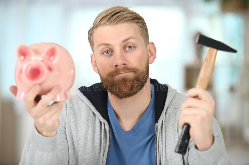 Man with Hammer and Piggy Bank Looking Regretful Stock Image - Image of loot, homefinances ...
