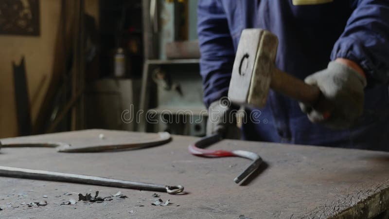 A Man is Hammering an Iron Hook with a Hammer Stock Image - Image of ...