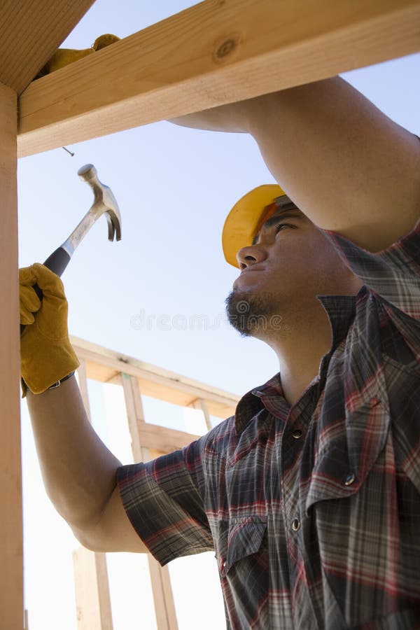 Worker Hammering Nail at Site Stock Image - Image of manual, architect ...
