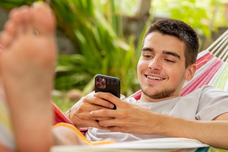 Man in Hammock in Summer with Mobile Phone Stock Image - Image of ...
