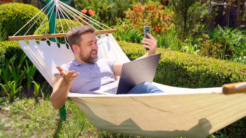 Man in Hammock, Work on Computer, Video Call Stock Photo - Image of ...