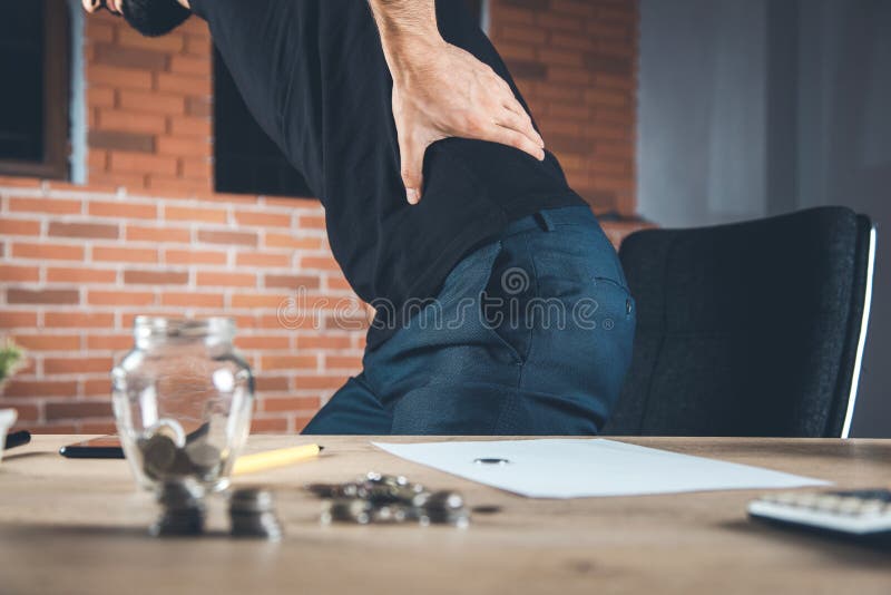 Man hand in back in office stock photo. Image of health - 210885046