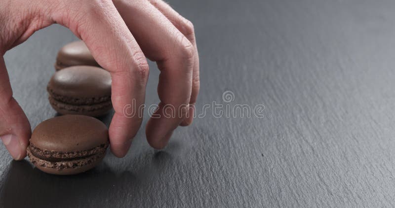 Man Hand Bring Chocolate Macarons on Slate Board Stock Image - Image of ...