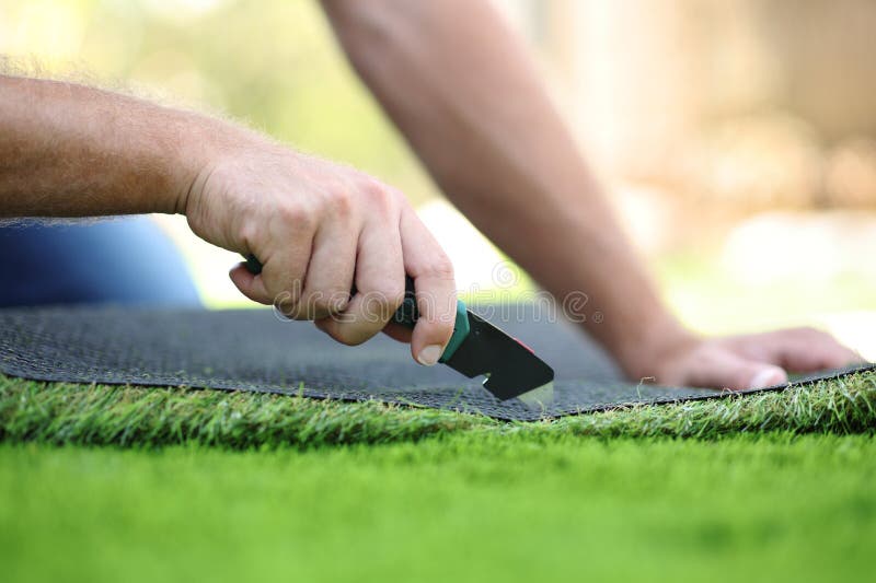 Man Hand Cutting and Installing Artificial Grass Stock Image - Image of ...