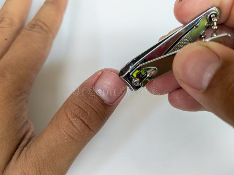 Man Hand Cutting Nails on a White Background Stock Image - Image of ...