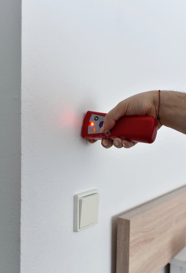 Man Detects Wires in the Wall. Contactless Voltage Tester. Stock Photo ...