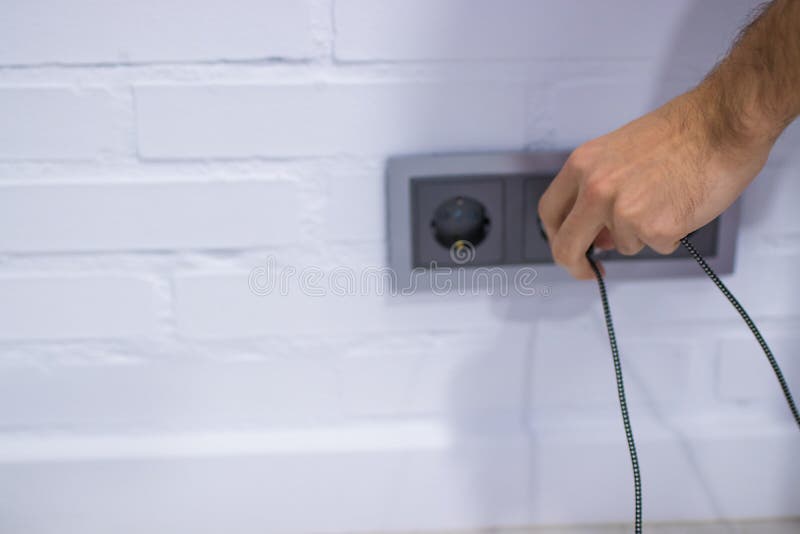 Man Plugging in or Unplugging an Electrical Plug in a Socket Stock ...