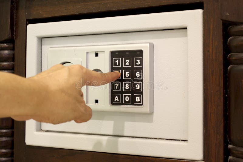 Man Hand Entering Code on Keypad of Mini Safe Box Stock Photo - Image ...