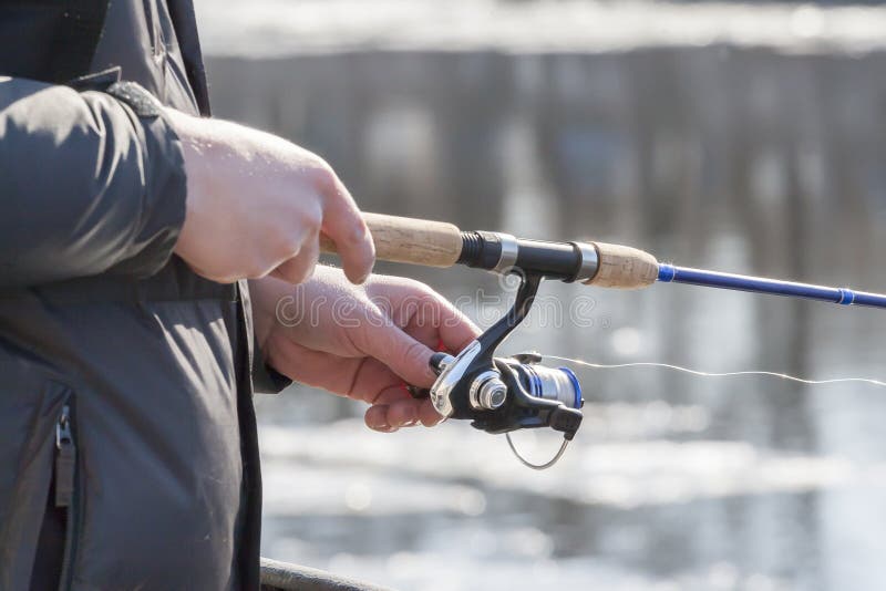 Man hand with fishing rod stock image. Image of fisherman - 69460431