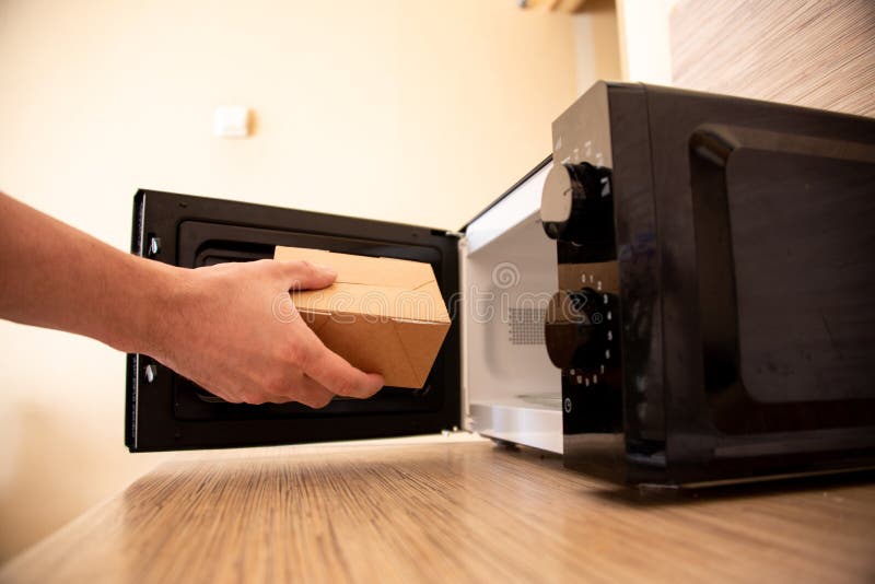 Man Hand Giving Foods into the Microwave for Warm Up Stock Photo ...