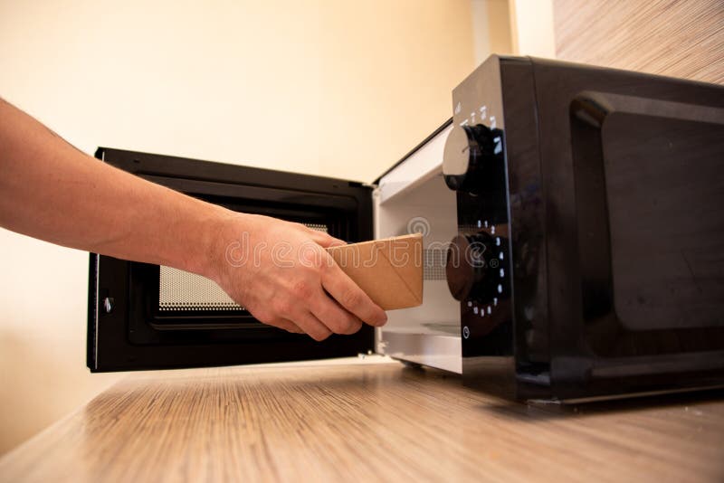 Man Hand Giving Foods into the Microwave for Warm Up Stock Image ...