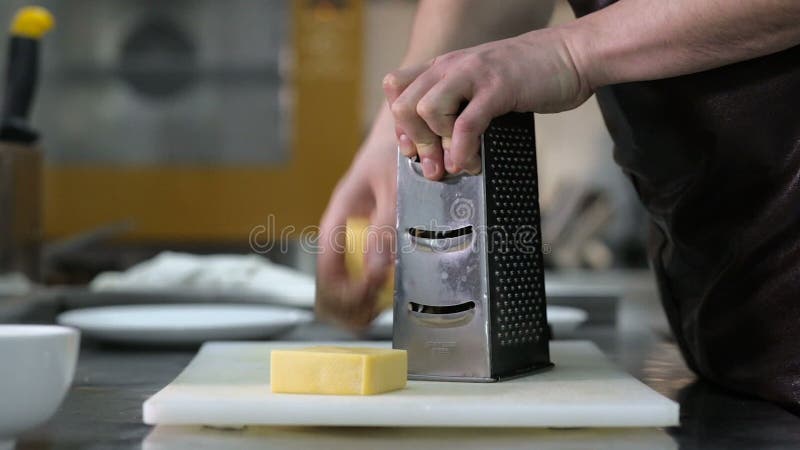 Hand grating yellow cheese stock footage. Video of action - 77255844