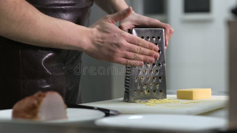 Man Hand Grating Yellow Cheese with a Metal Grater Stock Footage ...