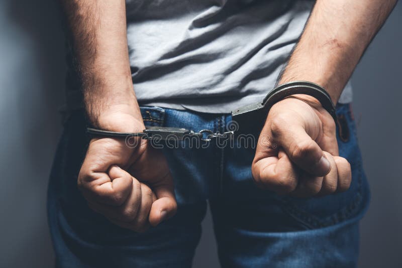 Man hand handcuffs in back stock photo. Image of justice - 203008726