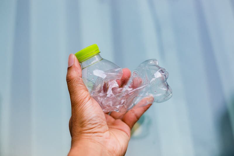Man Hand Hold and Crushing Plastic Bottle Stock Photo - Image of ...