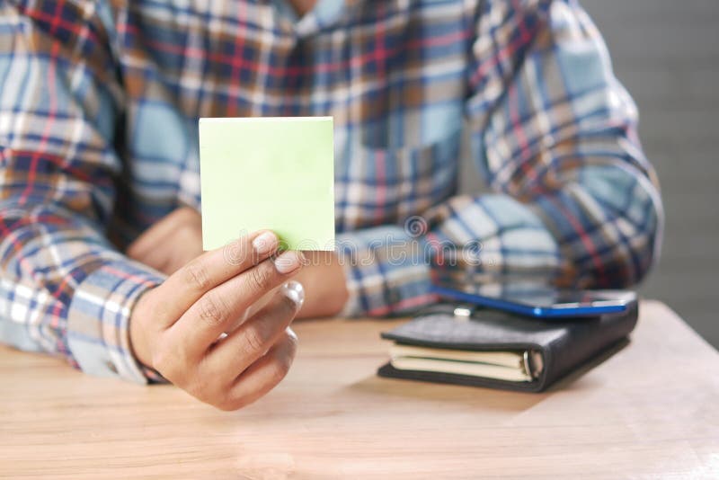 Man Hand Hold a Sticky Note while Sited Stock Image - Image of sticky ...