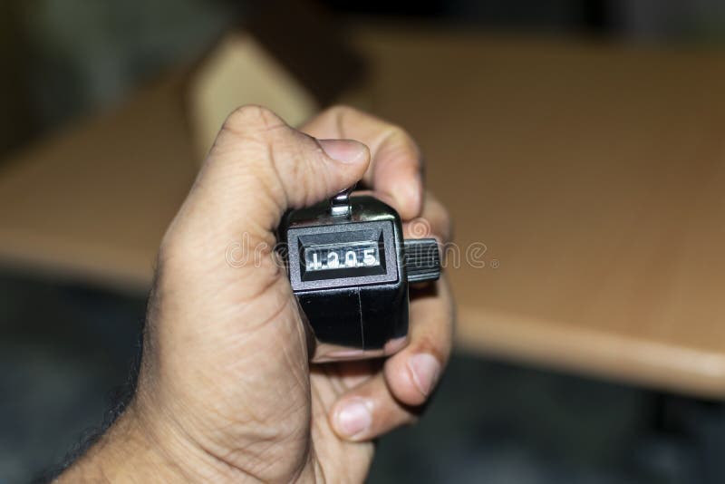 A Man Hand Holding Counting Machine Stock Photo - Image of device ...