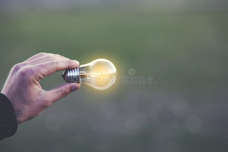 Man Hand Holding Glowing Light Bulb Stock Image - Image of energy, hand ...