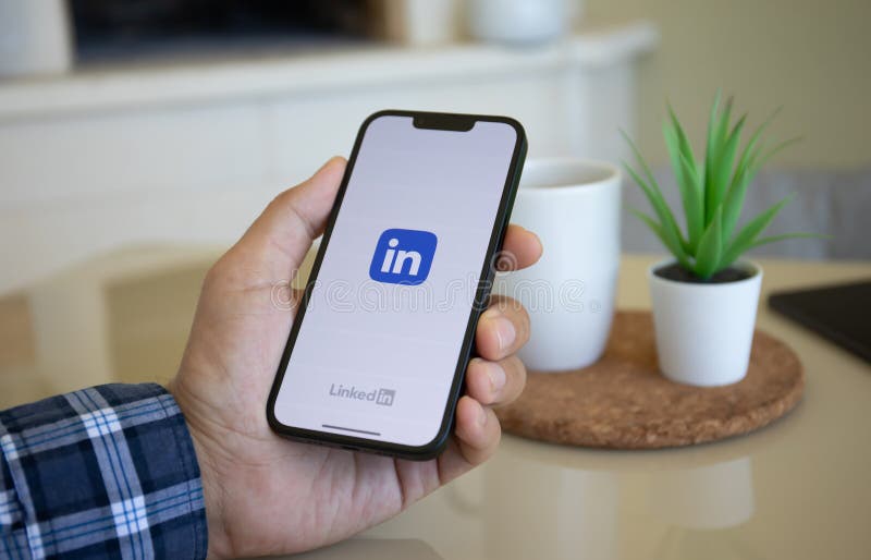 Man Hand Holding IPhone 14 and IPad with App LinkedIn Editorial Photo ...