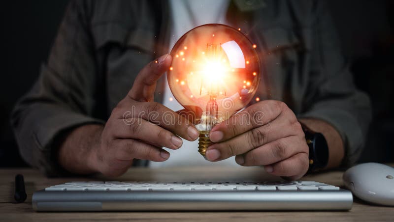 Man Hand Holding Light Bulb Above the Keyboard. Light Bulb Network ...