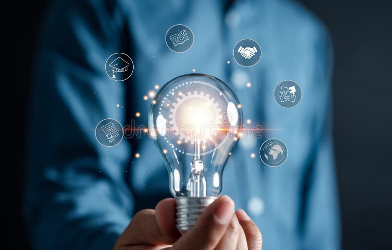 Man Hand Holding Lightbulb with Learning Educate and Graduation Concept ...