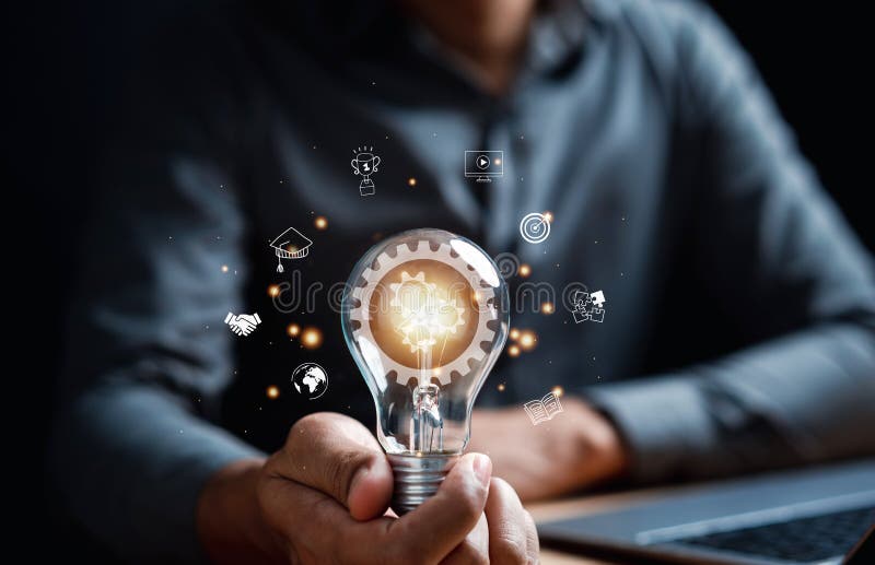 Man Hand Holding Lightbulb with Learning Educate and Graduation Concept ...