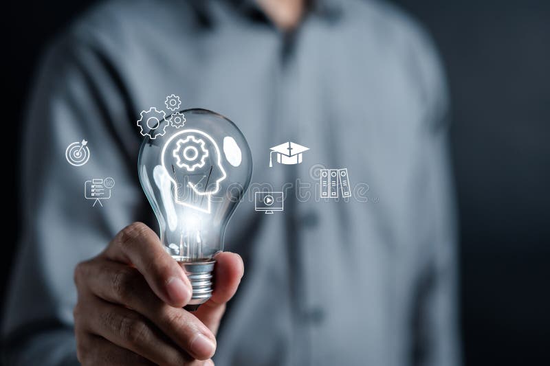 Man Hand Holding Lightbulb with Learning Educate and Graduation Concept ...