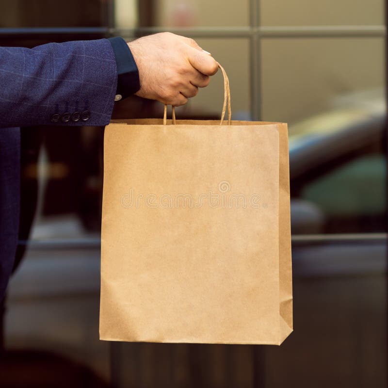 Man Hand Holding a Paper Bag Outside. Using a Paper Bag To Save ...