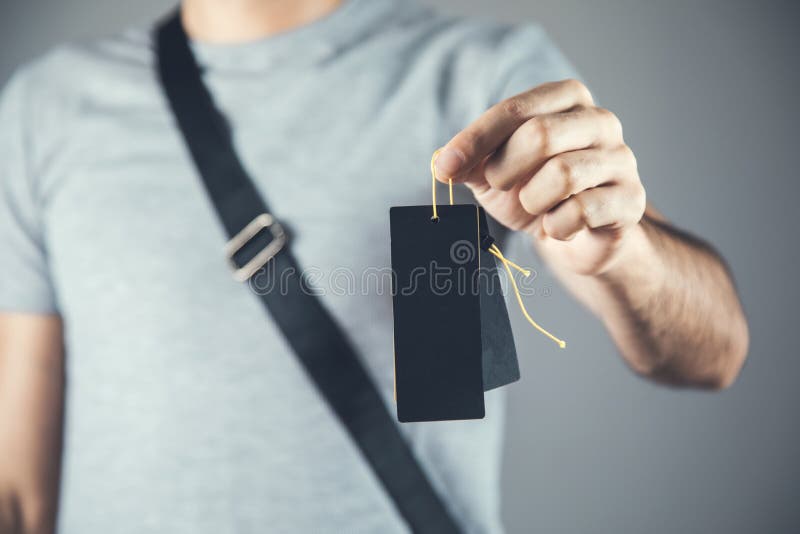 Man hand holding tag stock photo. Image of advertisement - 262960414
