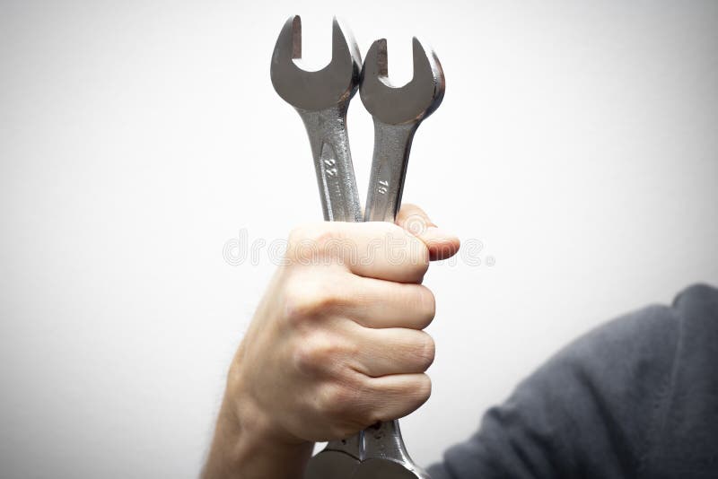 Wrenches in the hand stock image. Image of construction - 146091465