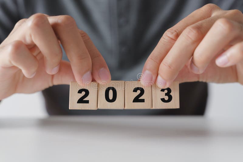 Man Hand Holding Wooden Cube Block With 2023 Year Text Start To Year