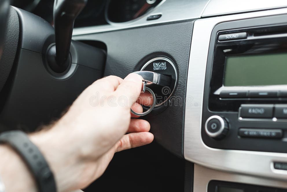 Man Hand Insert Key into the Lock of Ignition of Car. Car Ignition Key ...