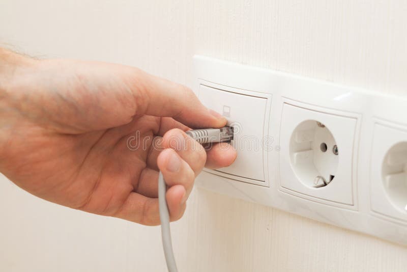 Man Hand Inserts the Network Cable To the Internet Outlet. Stock Image ...