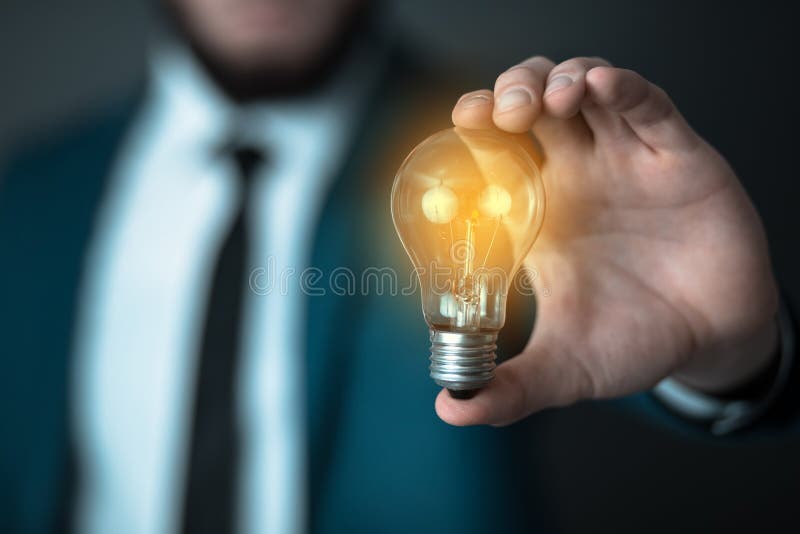 Man hand light bulb stock image. Image of holding, lightbulb - 193246905