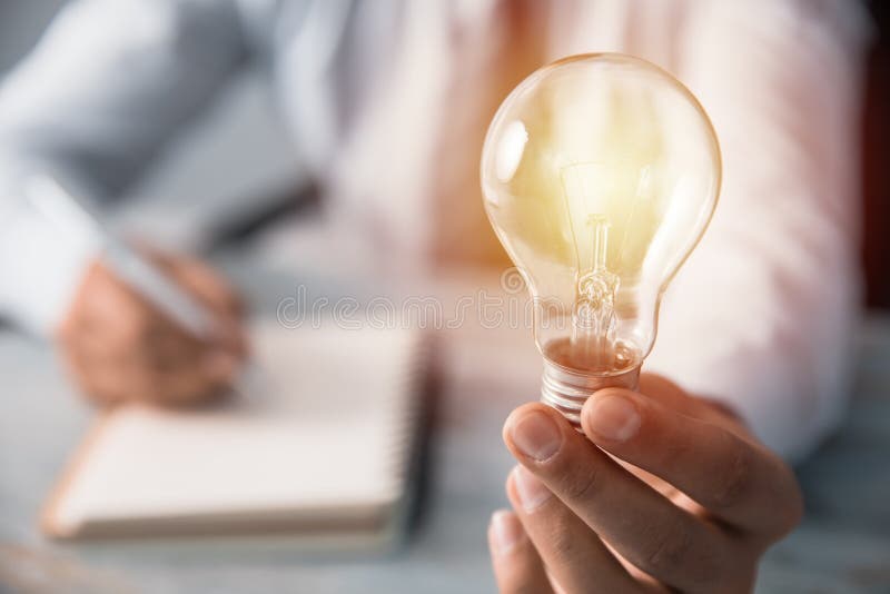 Man Hand Light Bulb with Notepad Stock Image - Image of exposure, think ...