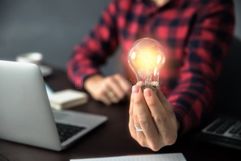 Man hand light bulb stock image. Image of hold, businessman - 196510603