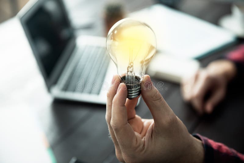 Man hand light bulb stock photo. Image of technology - 196362064