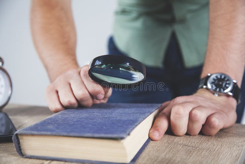 Man hand magnifier on book stock photo. Image of lonely - 154114966