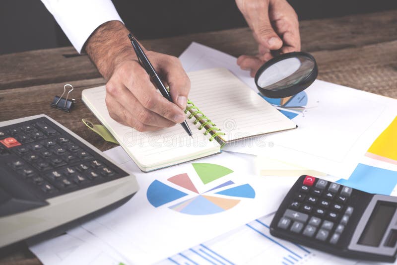 Man Hand Magnifier with Calculator and Graph Stock Image - Image of ...