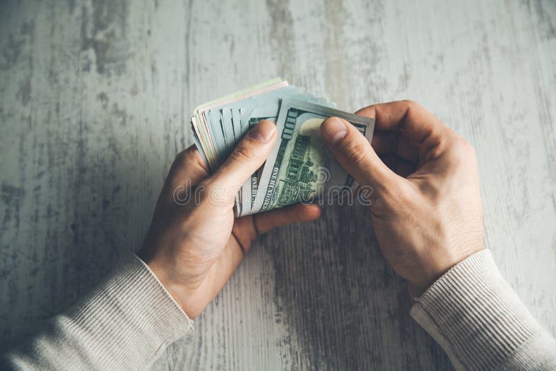 Man hand money on table stock photo. Image of dollar - 203007738