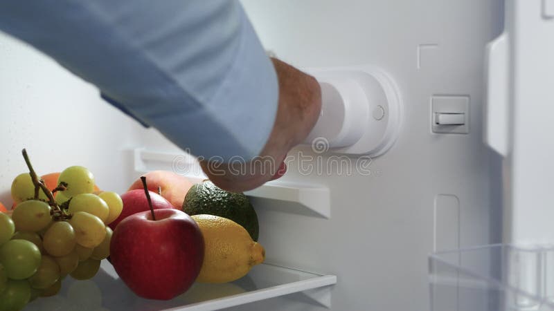 Man Hand Open the Kitchen Fridge Door and Set the Thermostat. Making ...
