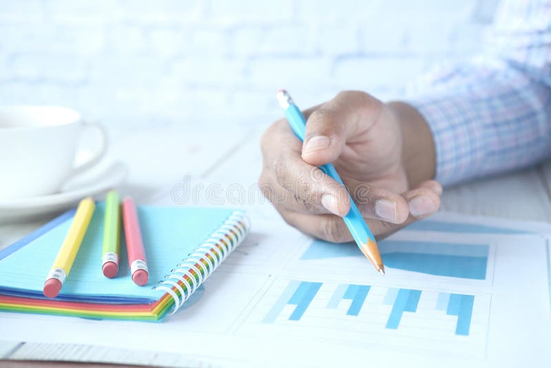 Man Hand with Pen Analyzing Bar Chart on Paper Stock Photo - Image of ...