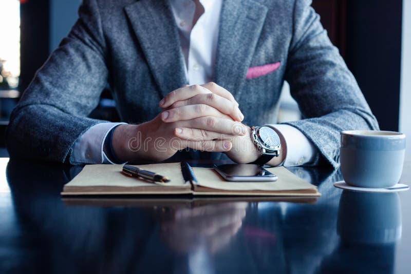 Man Hand with Pen Writing on Notebook on Table. Man Working at Coffee ...