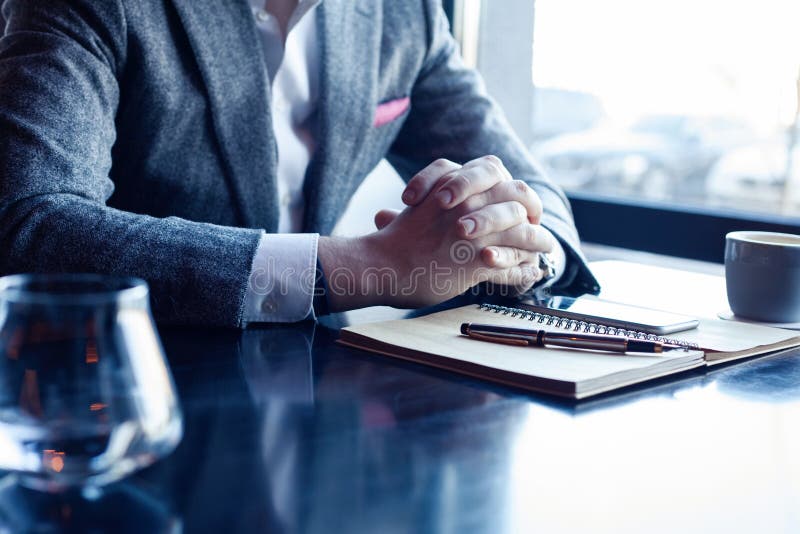 Man Hand with Pen Writing on Notebook on Table. Man Working at Coffee ...