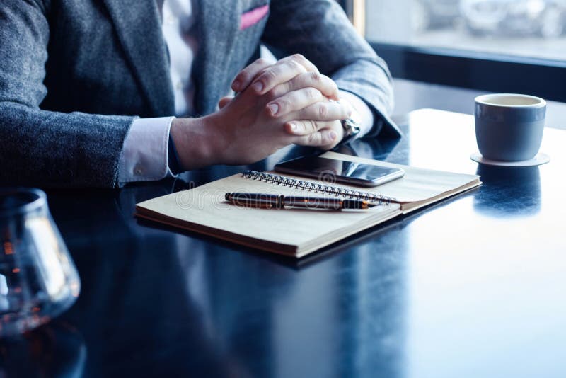 Man Hand with Pen Writing on Notebook on Table. Man Working at Coffee ...