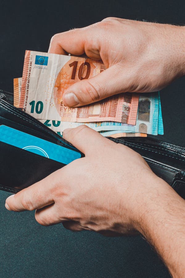 Man Hand Pulling Money from Wallet, Black Background and Black Wallet ...