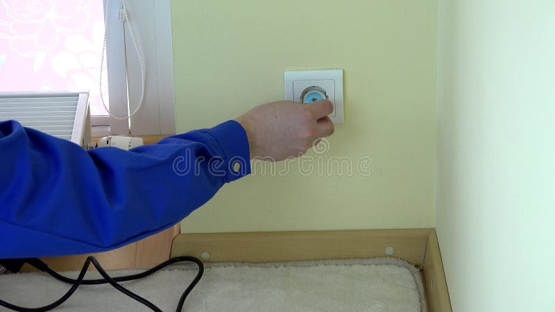 Man Hand Remove Plug Wire from Outlet and Insert Child Safety Plug ...