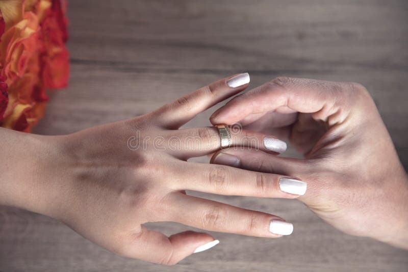 Hand with a Ring of Tasty Smoked Sausage on a White Background Stock ...